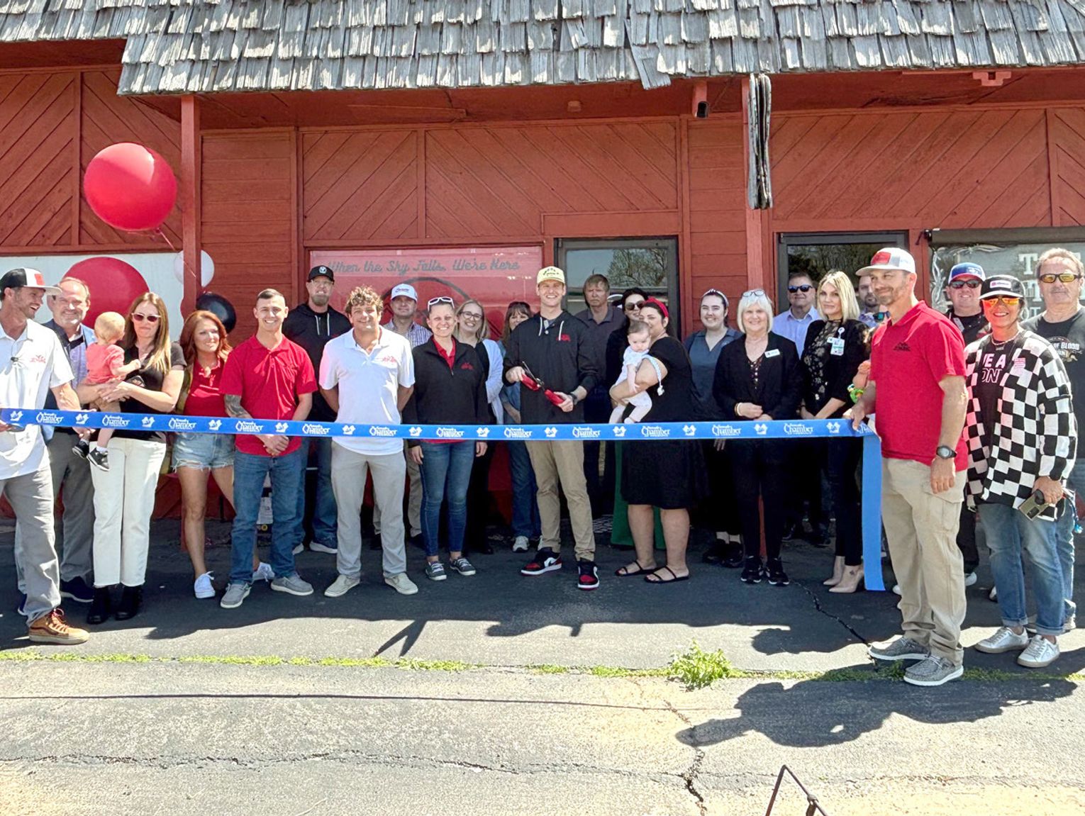 Dynamic Roofing and Construction cuts ribbon here